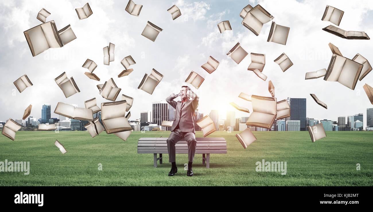 Many old books falling from above and student guy sitting on ben Stock ...