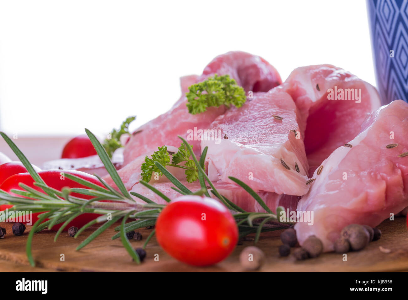 Horizontal photo with few long slices of pork meat with fat on the edge ...