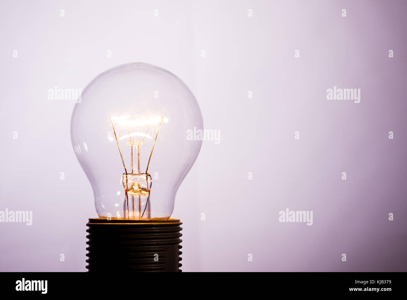 Horizontal photo with single glass bulb. The bulb is switched on and ...