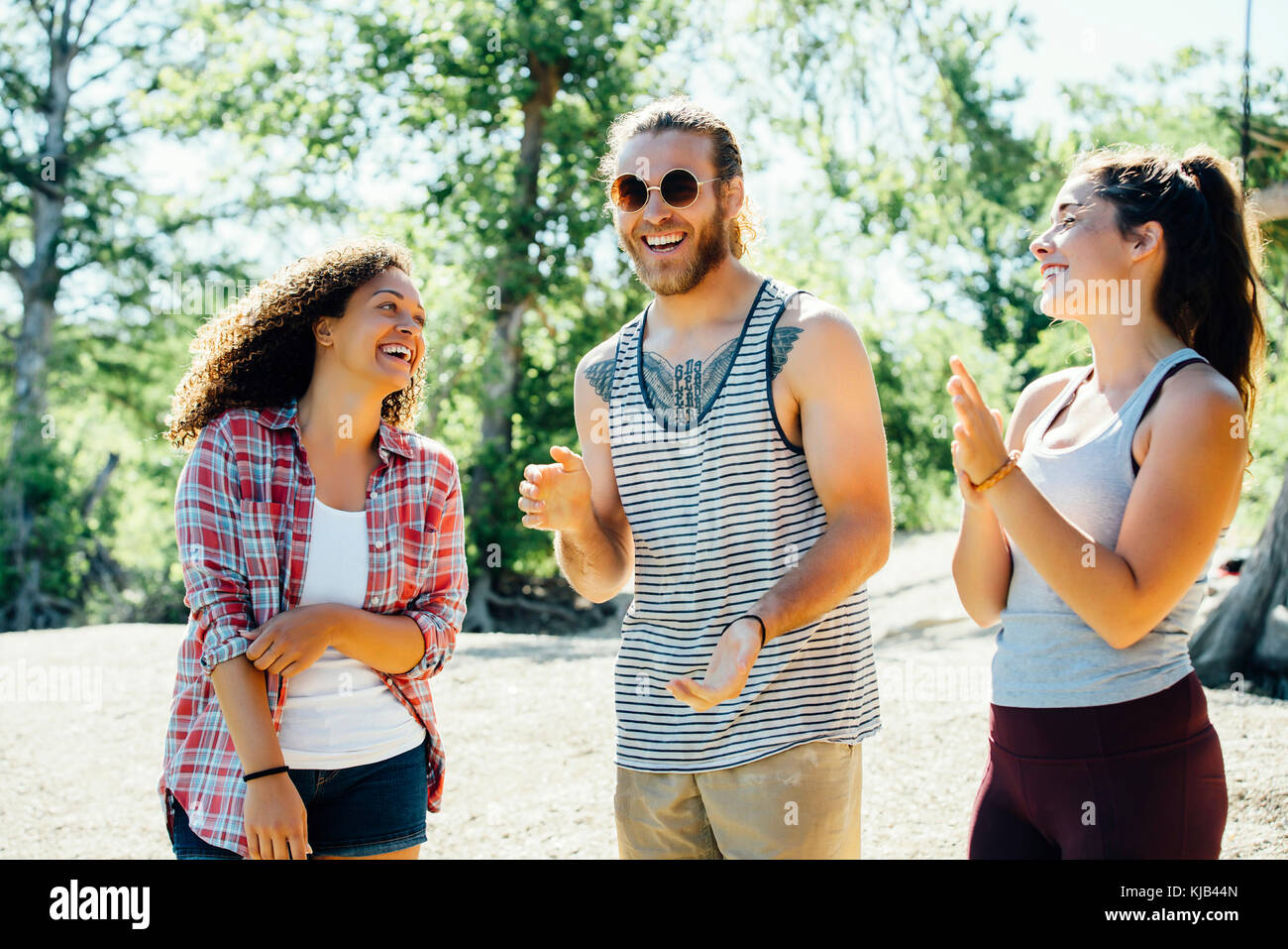 Friends laughing outdoors Stock Photo - Alamy