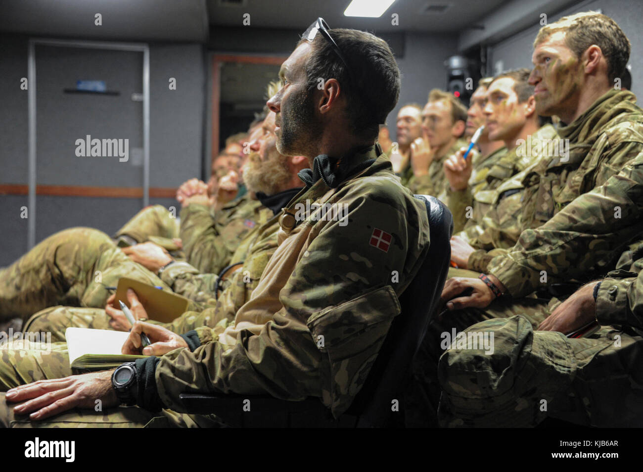 Danish, British and Lithuanian soldiers participate in an after action ...