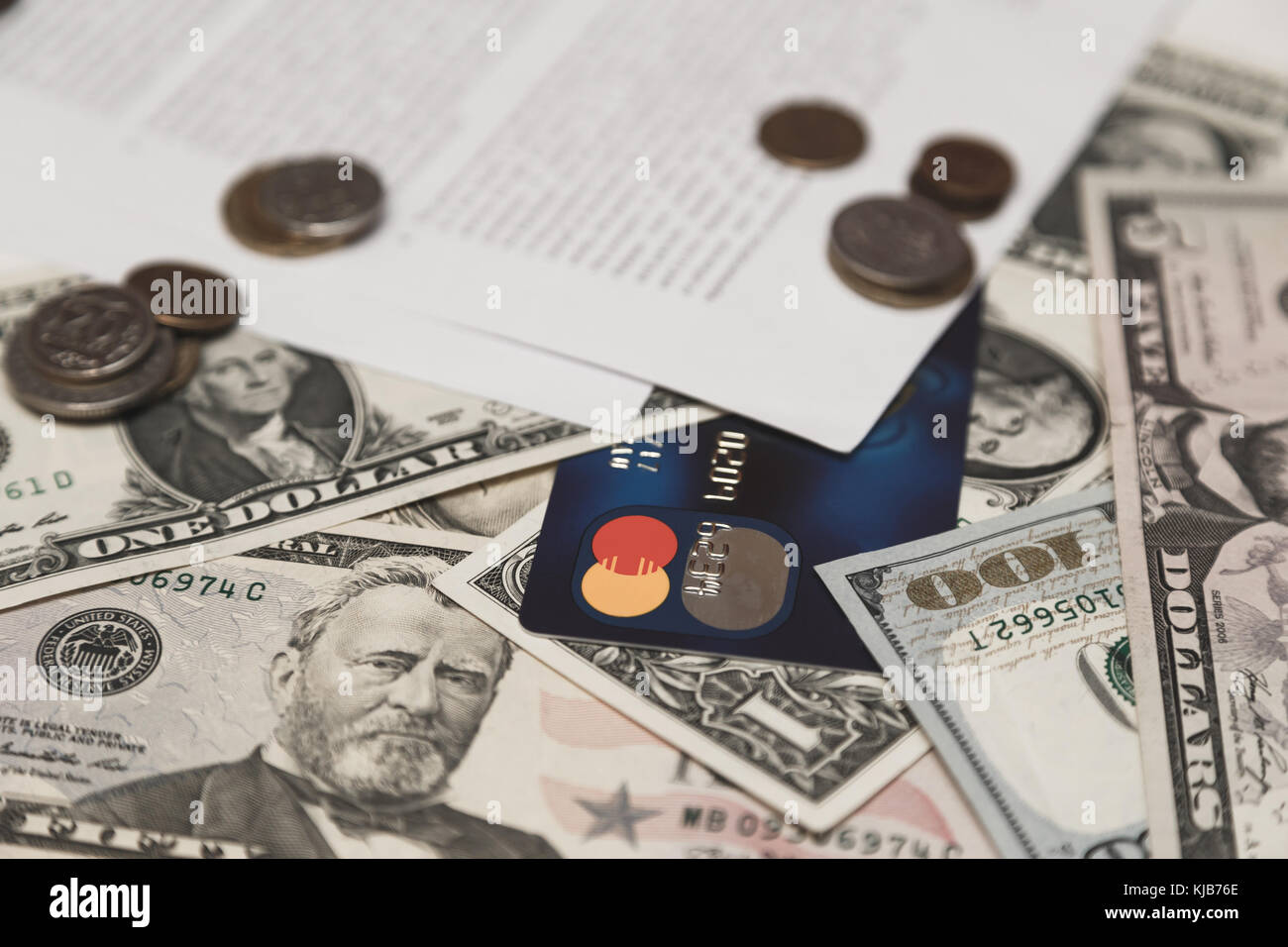 Bank credit card, moneys and coins and bank contract on background ...