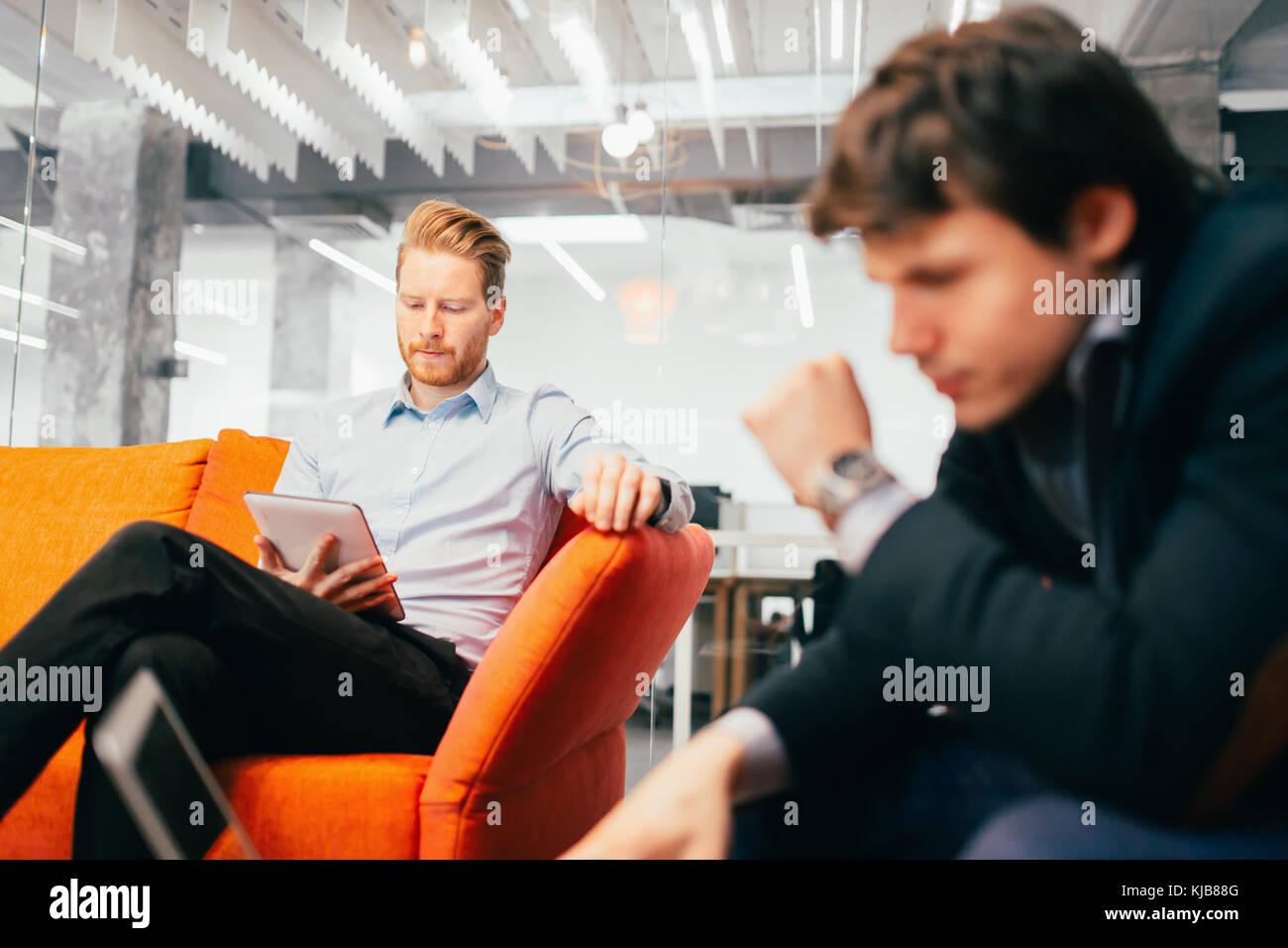 Business people looking at their devices Stock Photo - Alamy