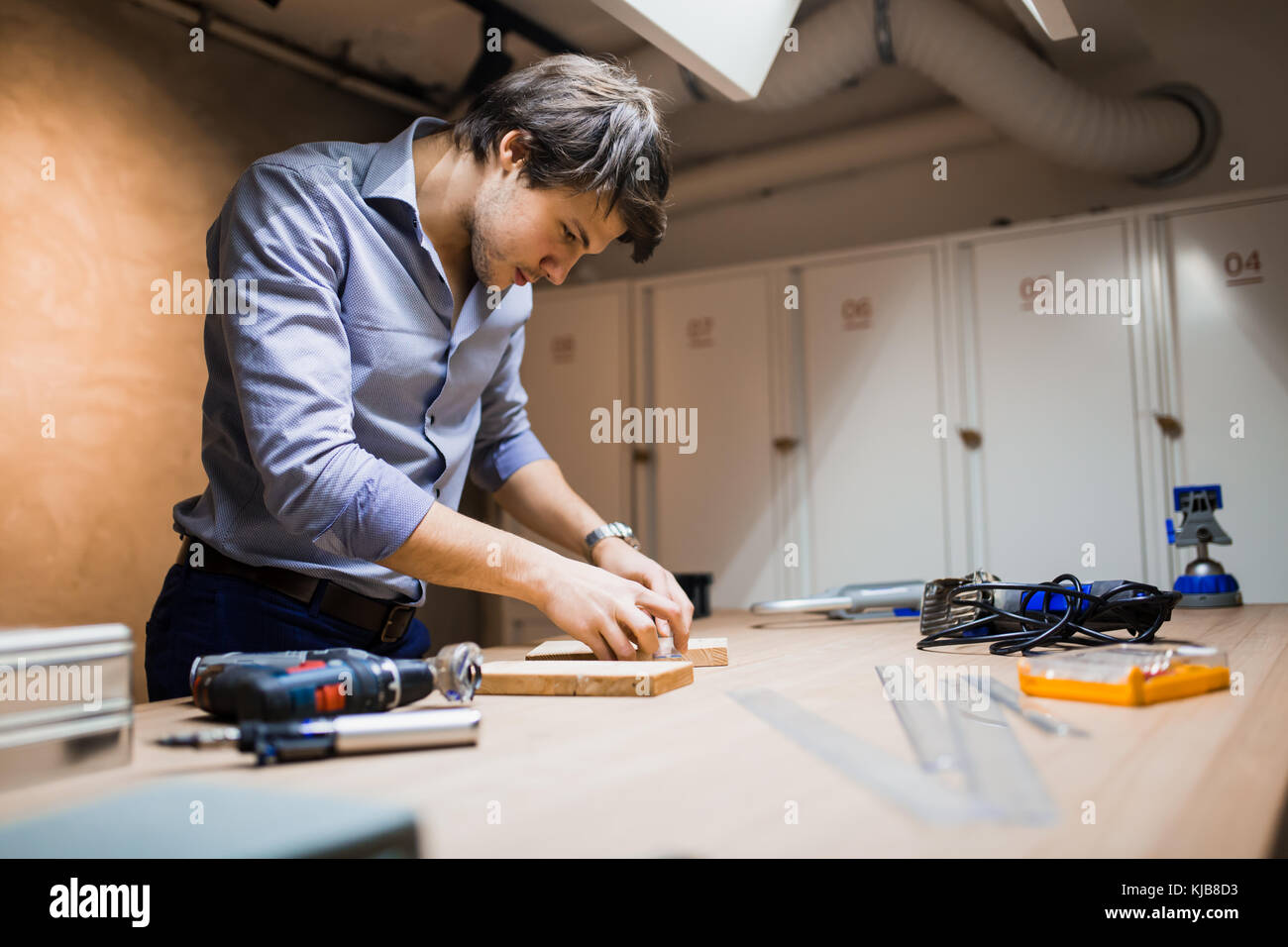 Handyman working with wood Stock Photo - Alamy