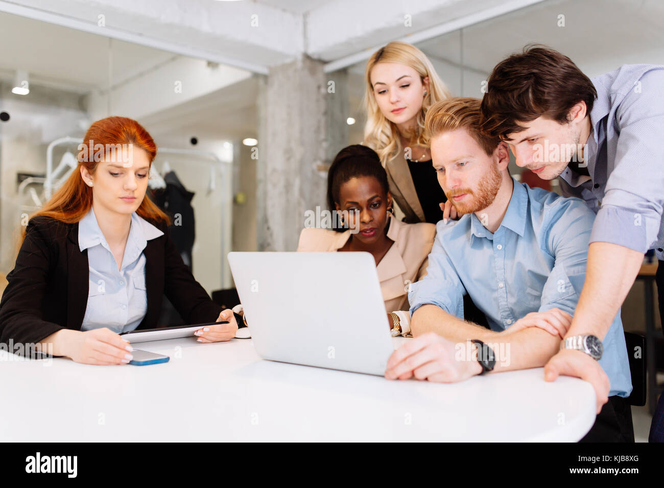Business colleagues sitting at desk Stock Photo - Alamy