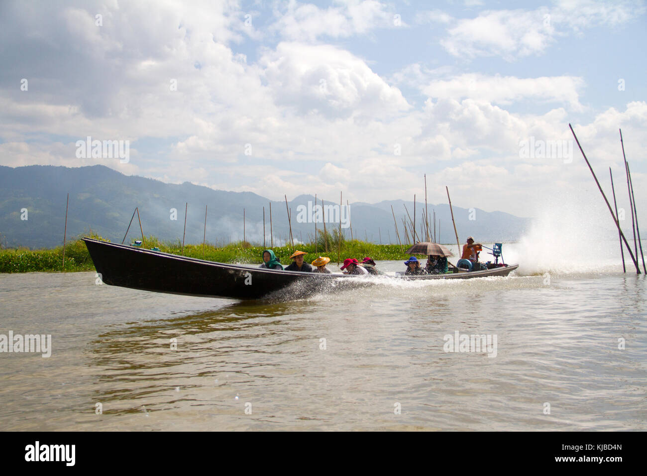 Tourists ride on motorboats across Inle Lake in Myanmar. Inle lake is a ...