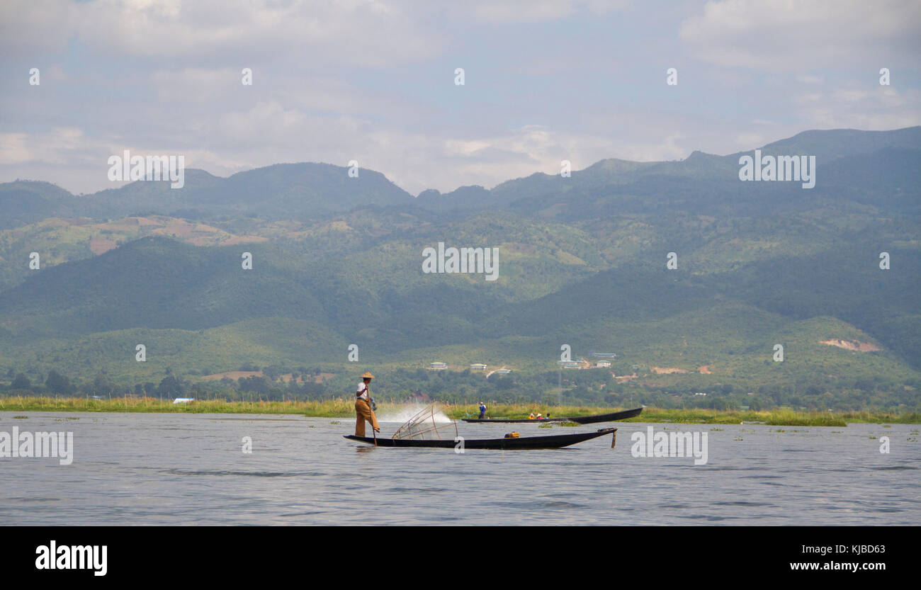 A fisherman paddles on Inle Lake in Myanmar. Inle lake is a major ...