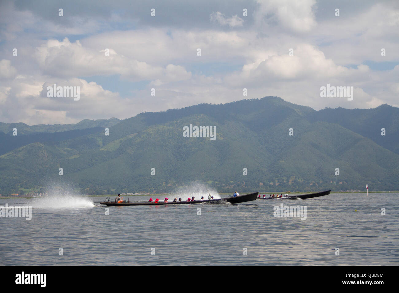 Tourists ride on motorboats across Inle Lake in Myanmar. Inle lake is a ...