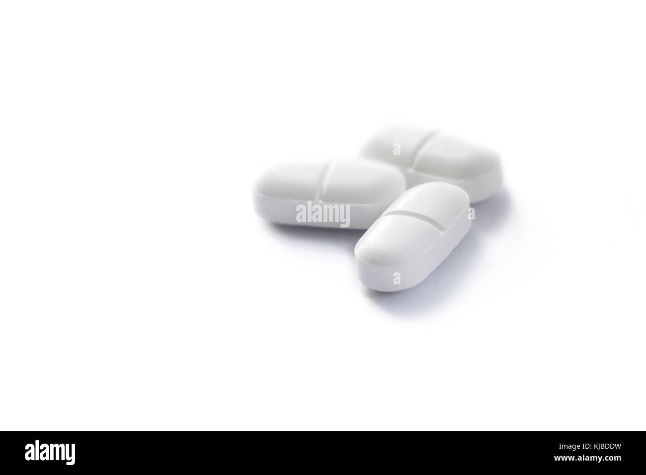 close up of a group of white tablets isolated on a white background ...