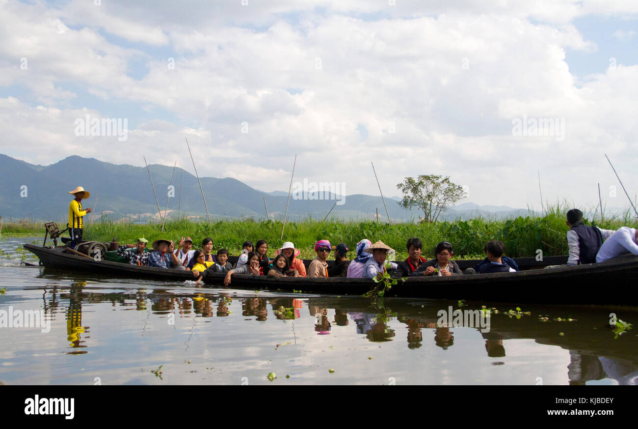 Tourists ride on motorboats across Inle Lake in Myanmar. Inle lake is a ...