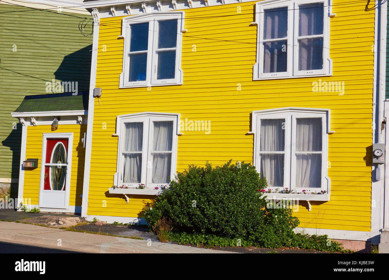 Typical traditional bright yellow timber house, St John's, Newfoundland ...