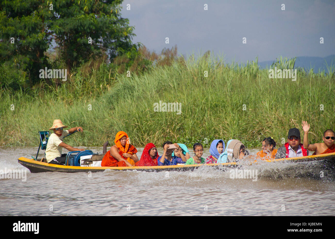 Tourists ride on motorboats across Inle Lake in Myanmar. Inle lake is a ...