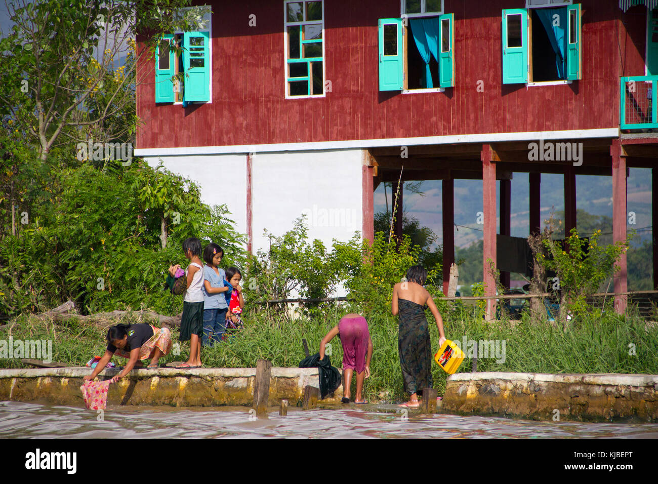People bath and wash clothes on Inle Lake in Myanmar. Inle lake is a ...