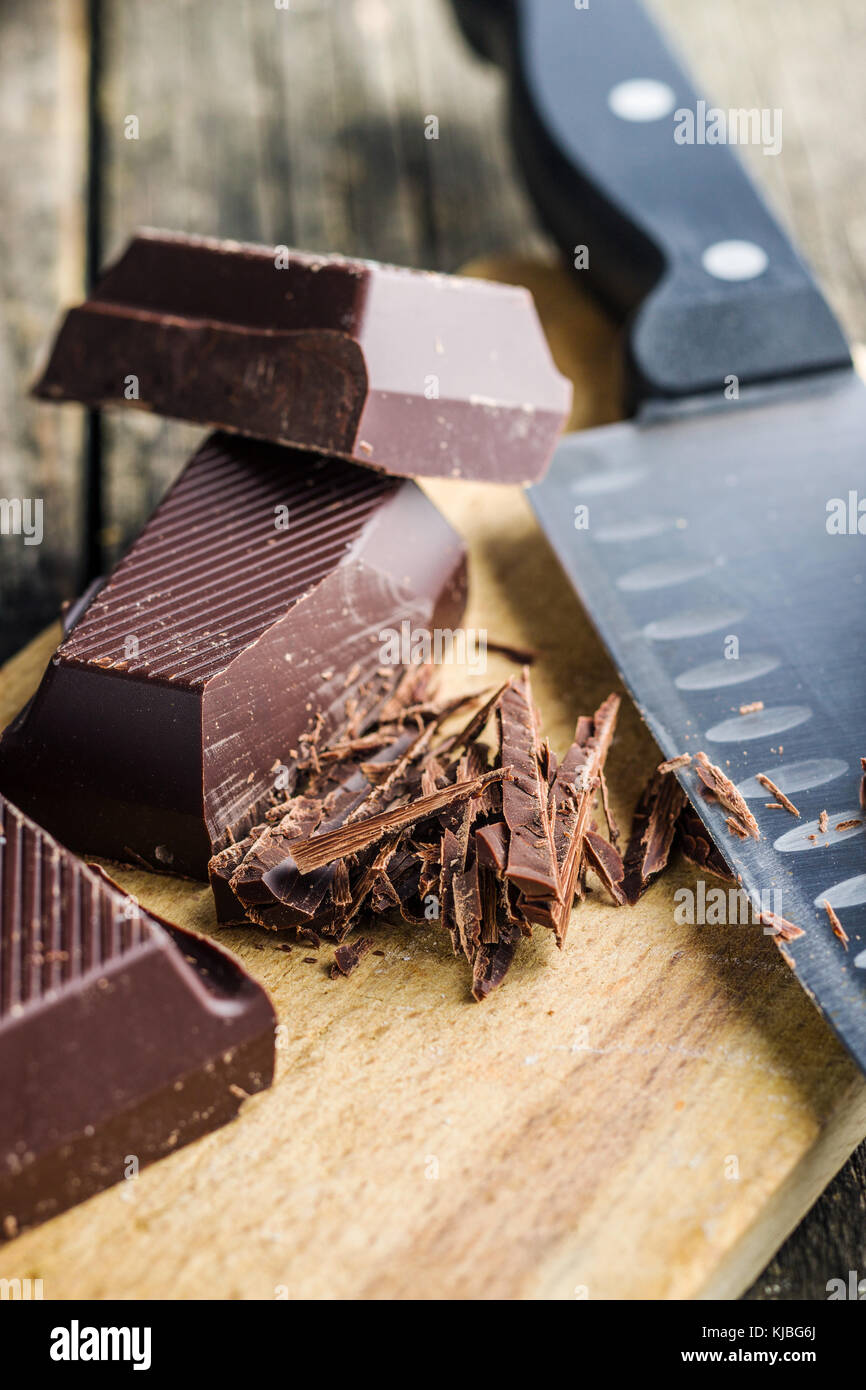 Chopped dark chocolate and knife Stock Photo - Alamy