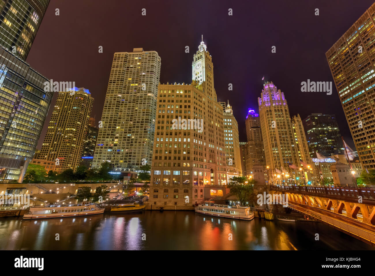 Chicago River Walk with urban skyscrapers illuminated with lights and ...