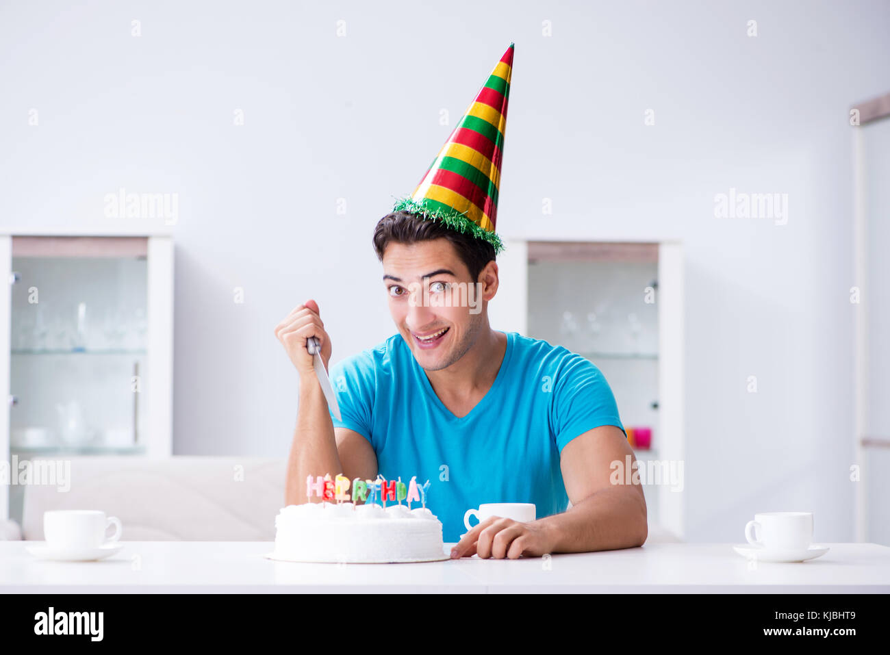 Young man celebrating birthday alone at home Stock Photo - Alamy