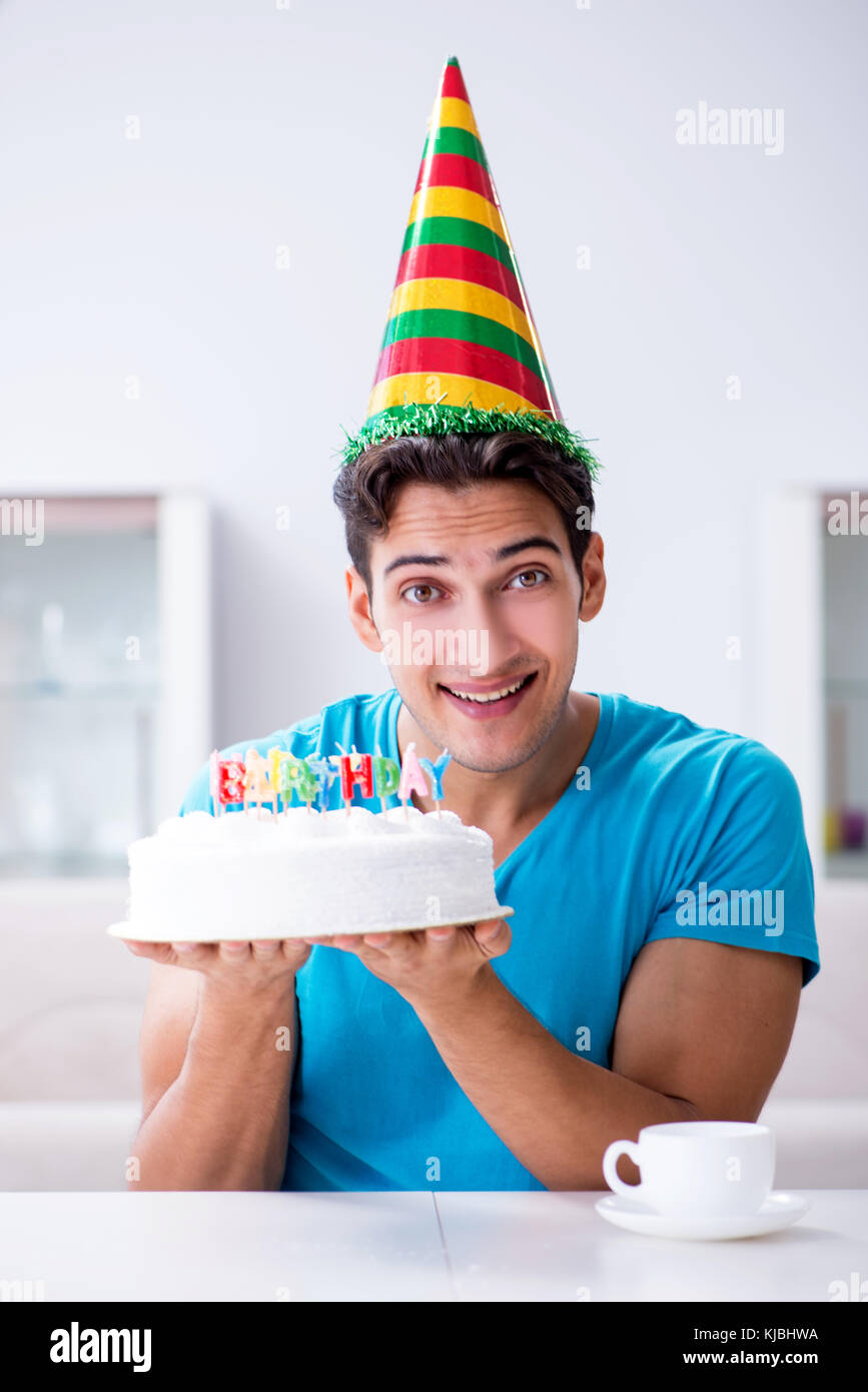 Young man celebrating birthday alone at home Stock Photo - Alamy