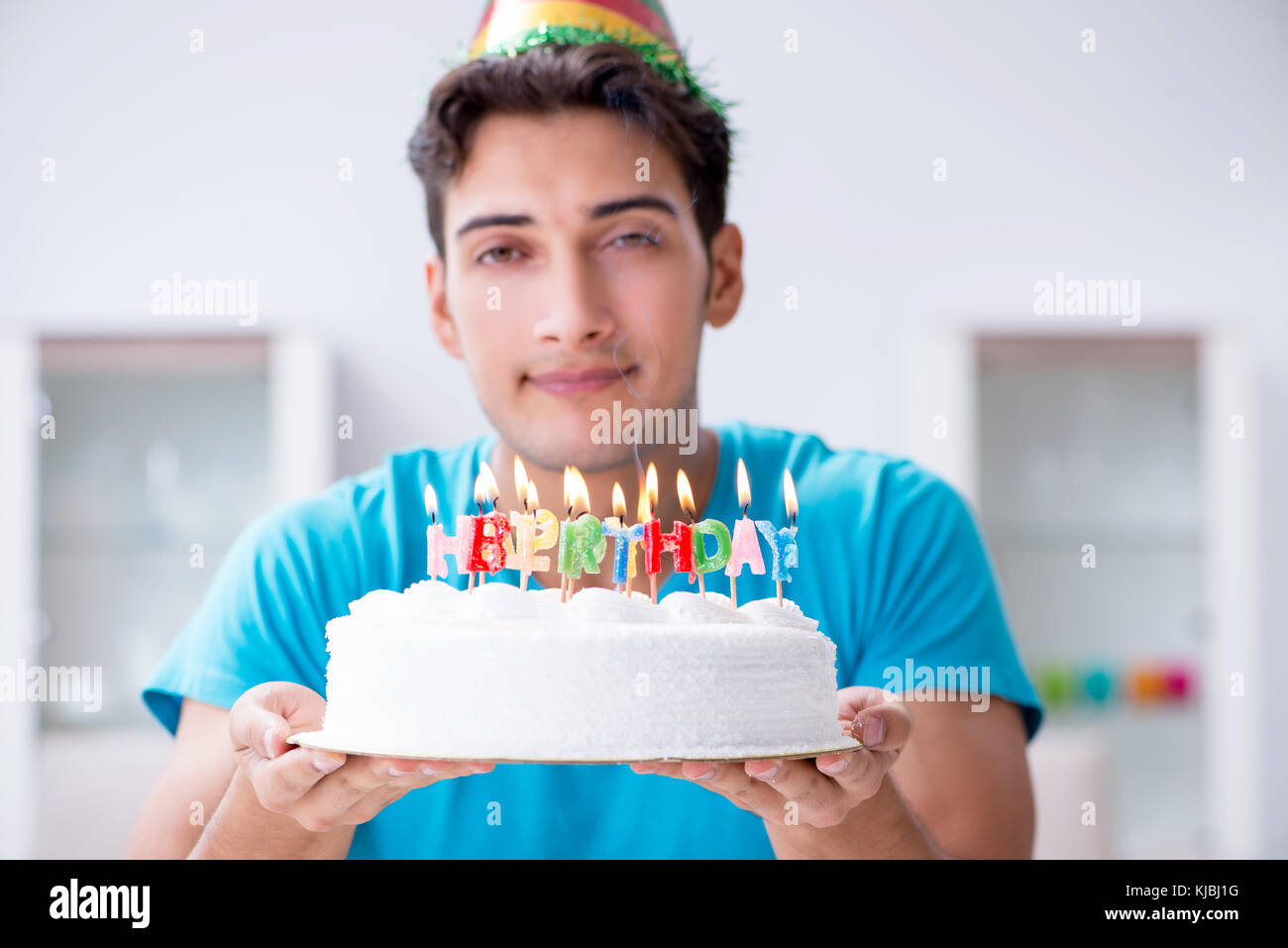 Young man celebrating birthday alone at home Stock Photo - Alamy