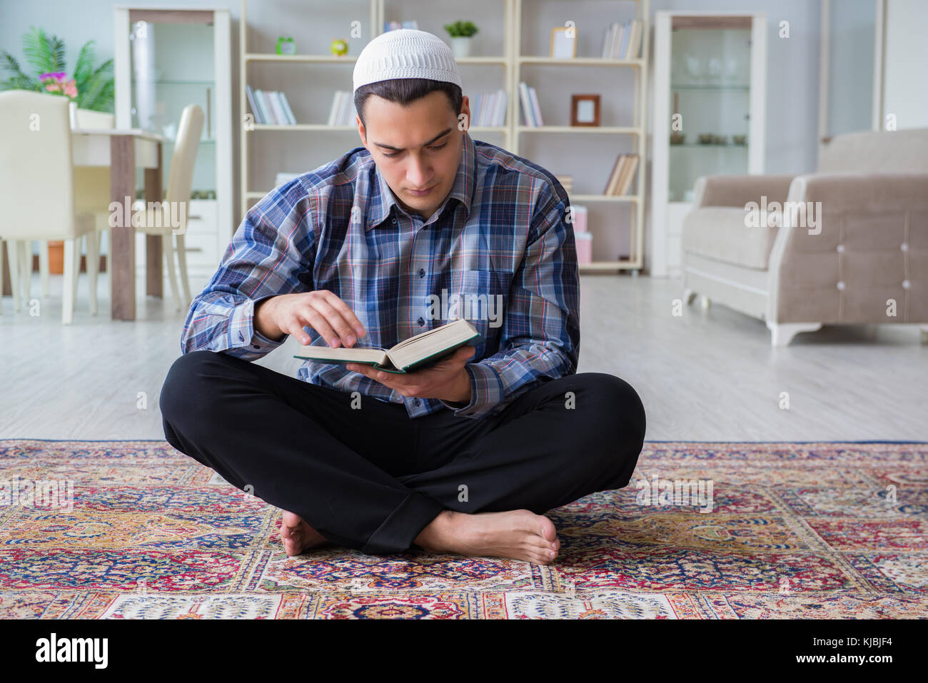 Young muslim man praying at home Stock Photo - Alamy