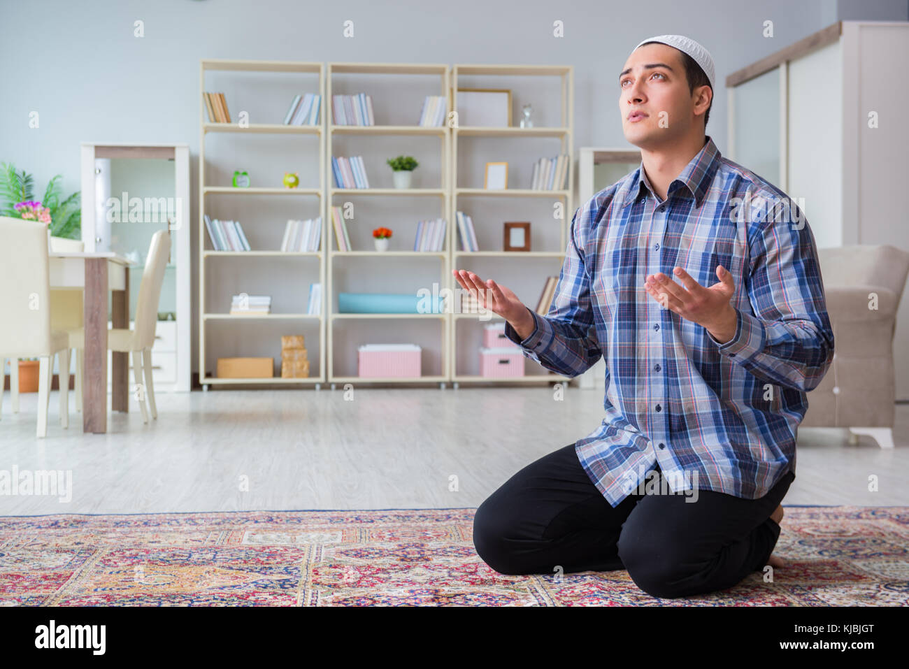 Young muslim man praying at home Stock Photo - Alamy
