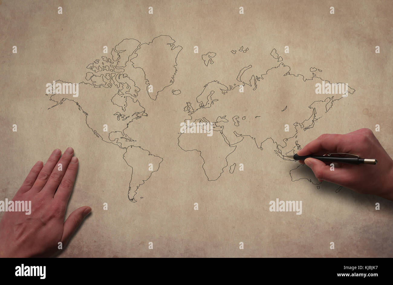 Hands drawing world map. Outline world map on the old paper texture ...
