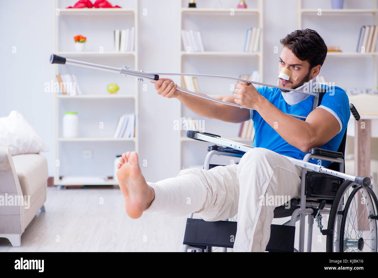 Injured young man recovering at home Stock Photo - Alamy