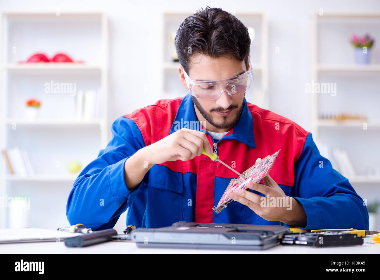 Repairman working in technical support fixing computer laptop ...