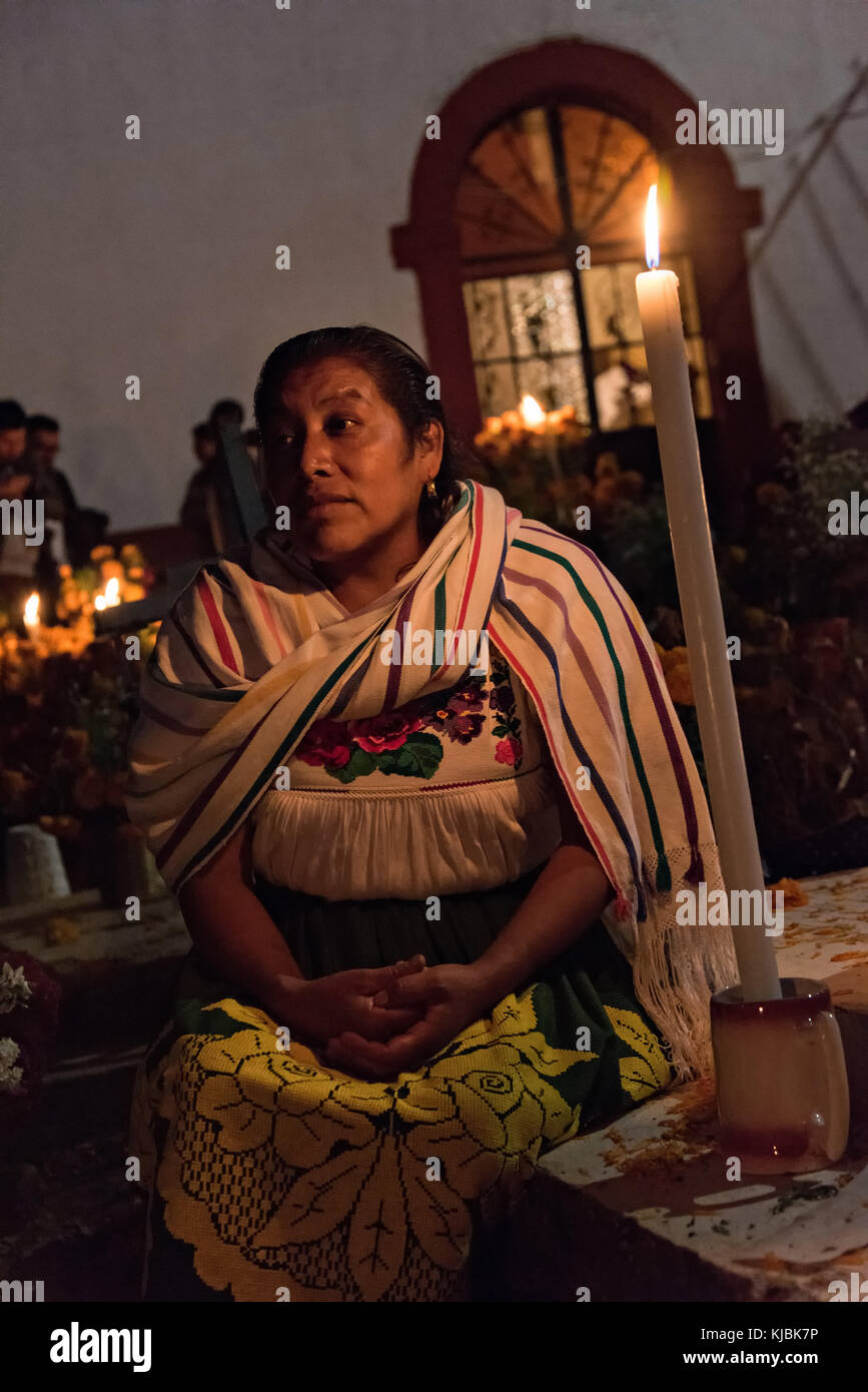 A Purepecha indigenous woman holds vigil at the gravesite of a family ...