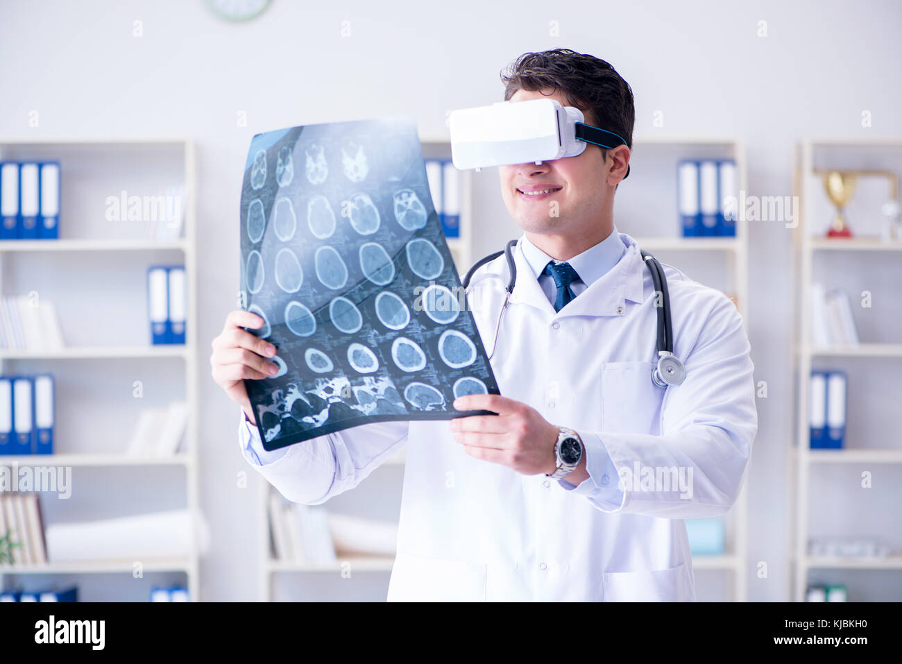 Young doctor looking at MRI scan through VR glasses Stock Photo - Alamy