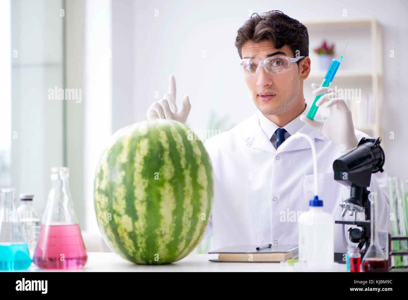 Scientist testing watermelon in lab Stock Photo - Alamy