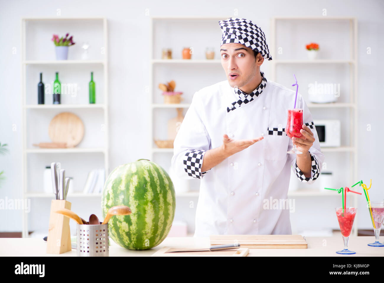 Male cook with watermelon in kitchen Stock Photo - Alamy