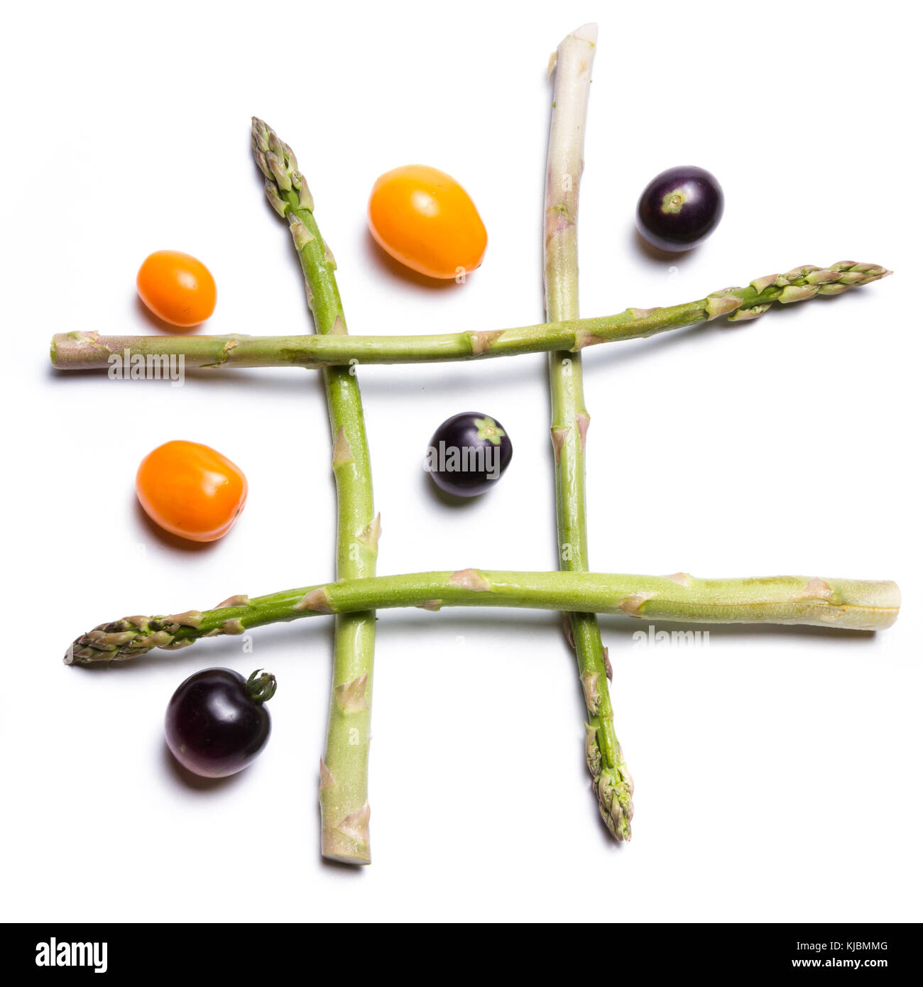 concept for healthy food games using asparagus and tomatoes to play tic ...