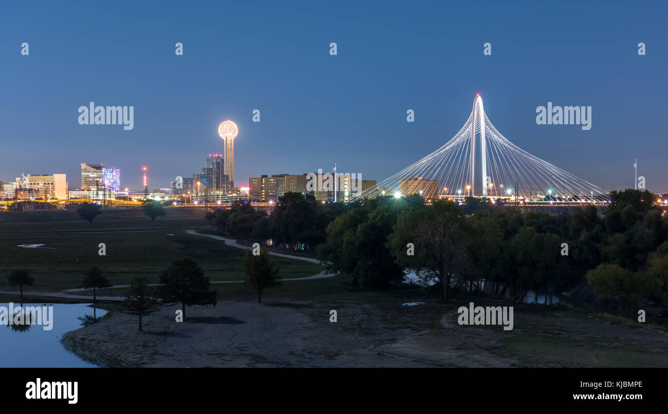 Downtown Dallas skyline with the Margaret Hunt Hill Bridge at dusk in ...