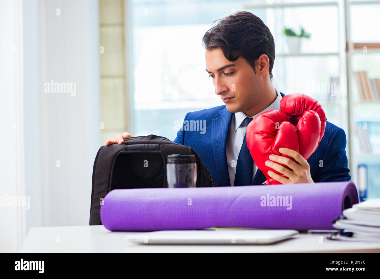 Man with boxing gloves in the office Stock Photo - Alamy