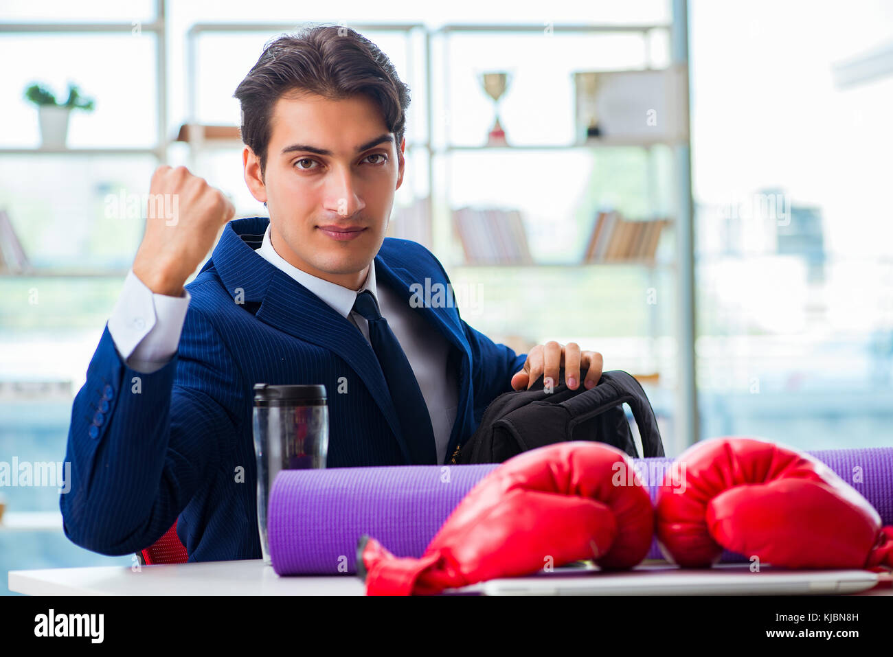 Man with boxing gloves in the office Stock Photo - Alamy