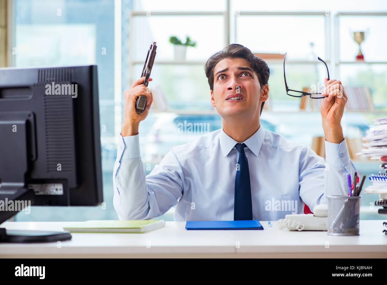 Angry businessman with gun thinking of committing suicide Stock Photo ...