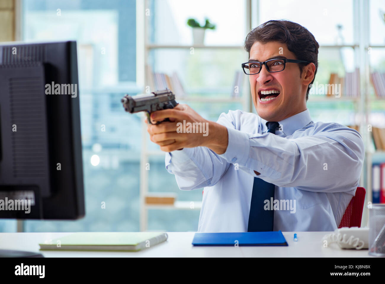 Angry businessman with gun thinking of committing suicide Stock Photo ...