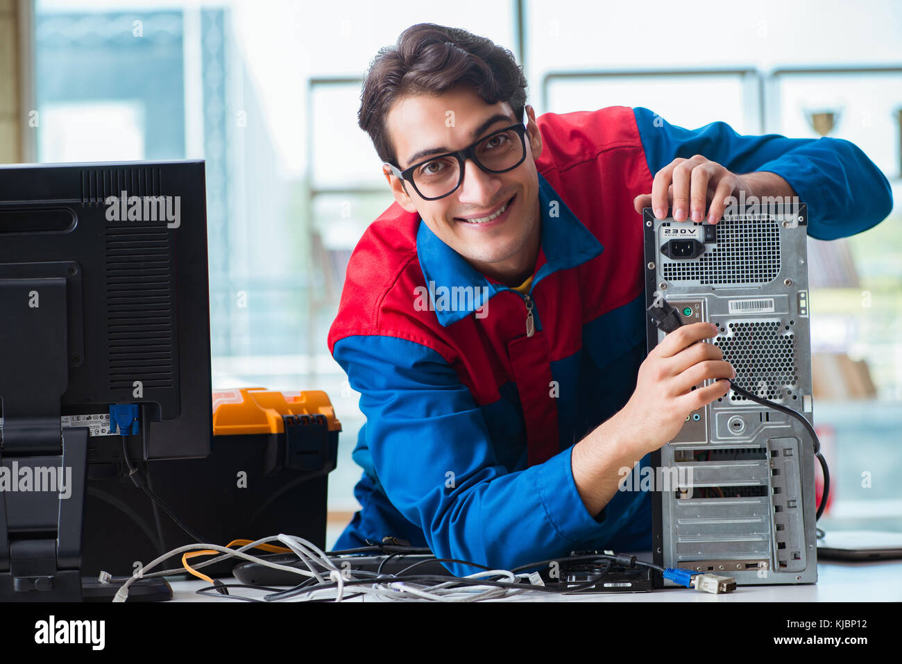 Computer repairman working on repairing computer in IT workshop Stock ...