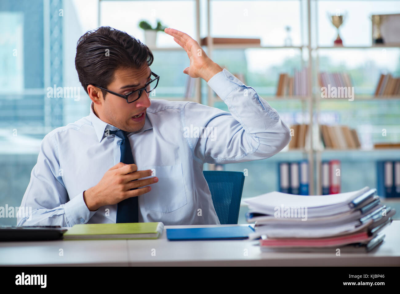 Businessman suffering from excessive armpit sweating Stock Photo - Alamy
