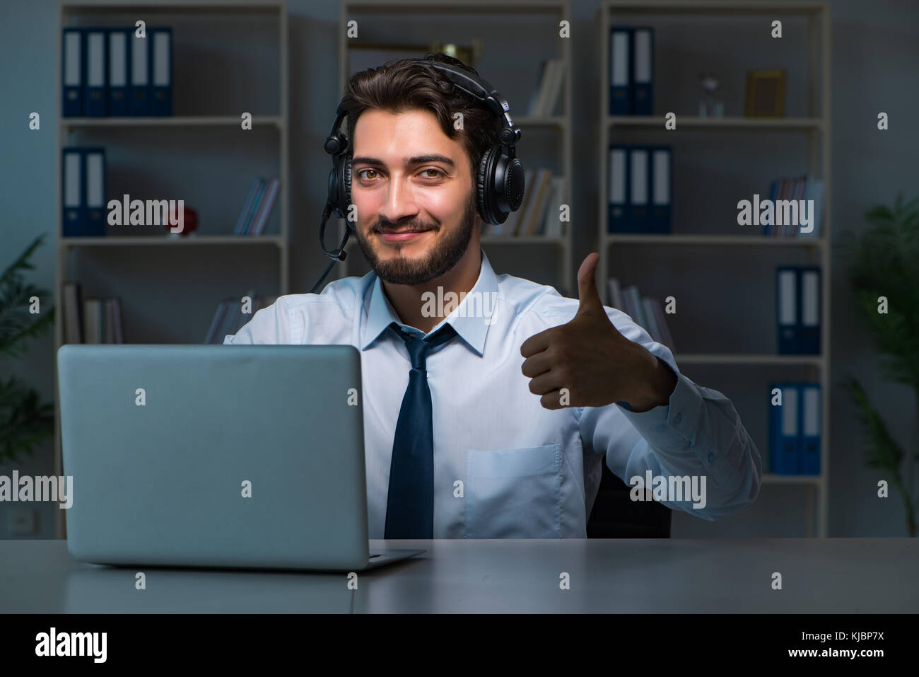 Young man in call center concept working late overtime Stock Photo - Alamy