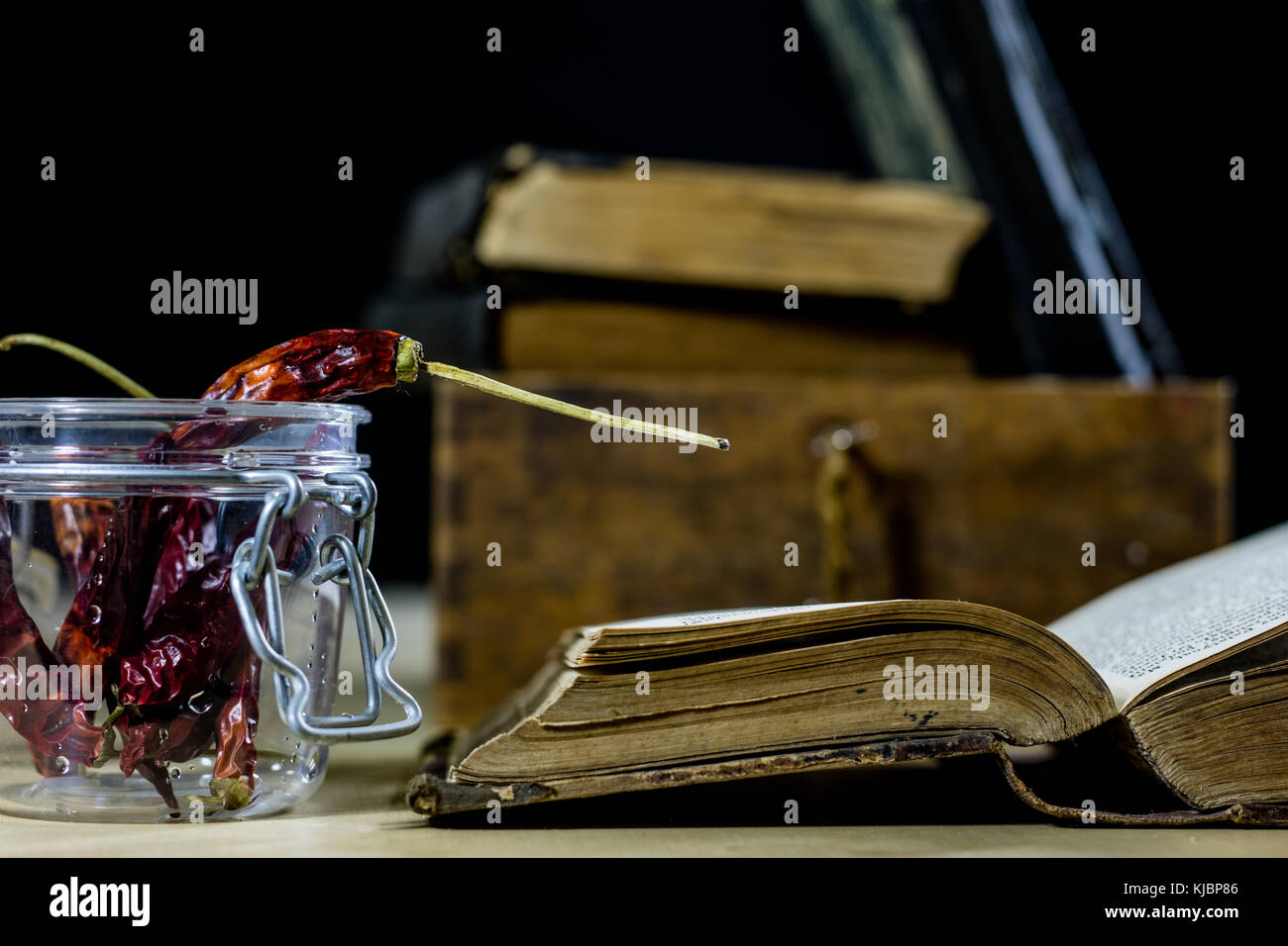 Old books and spices. Dried peppers and recipes. Old kitchen table ...