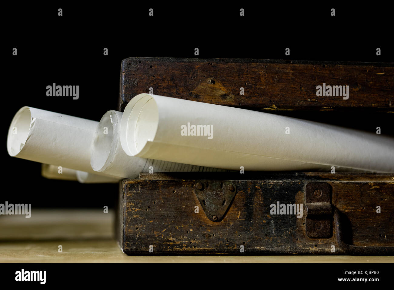 Old rolls and plans in folded paper rolls. Old book and case. Documents ...