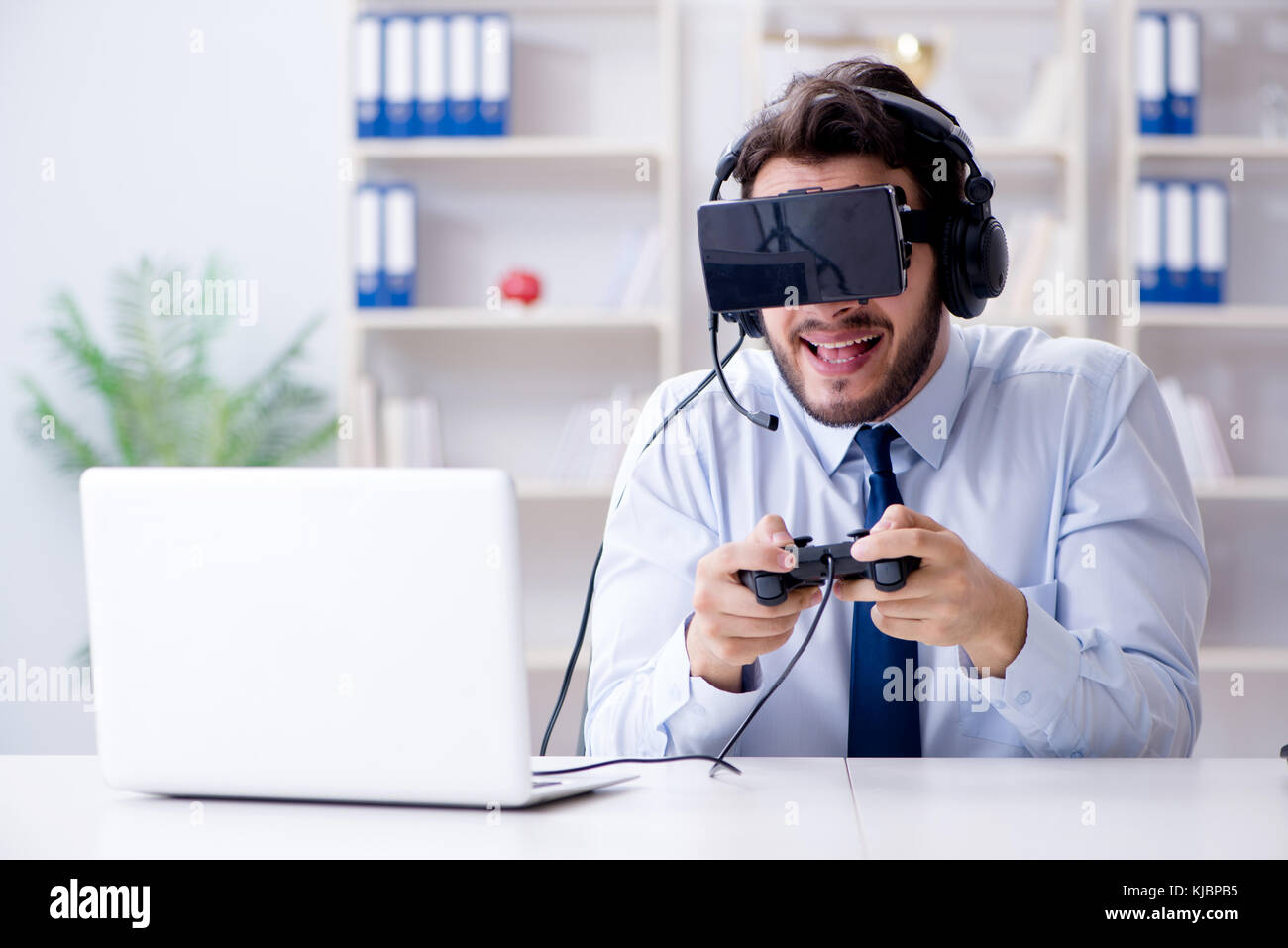 Businessman gamer in office playing games Stock Photo - Alamy