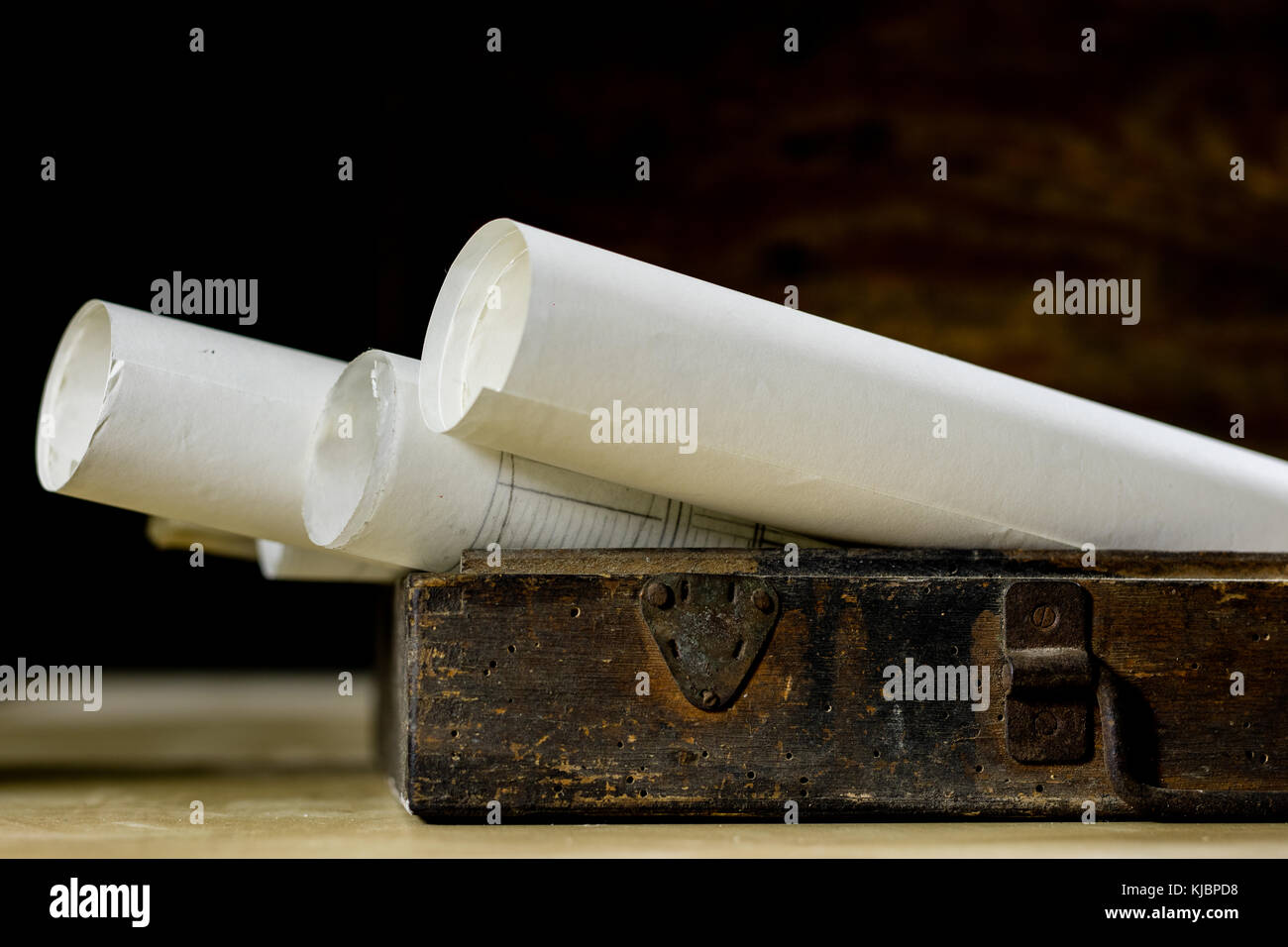 Old rolls and plans in folded paper rolls. Old book and case. Documents ...