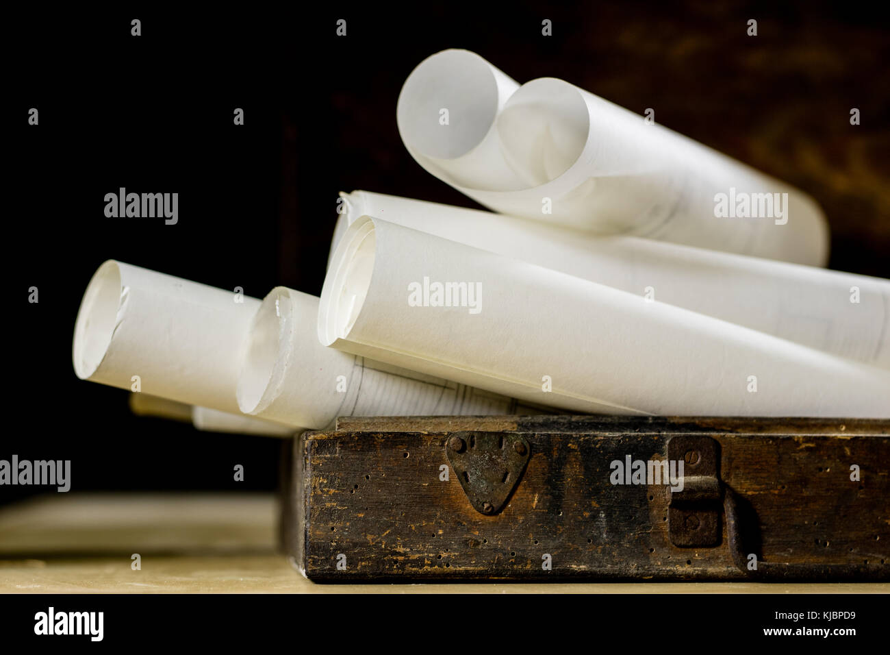 Old rolls and plans in folded paper rolls. Old book and case. Documents ...