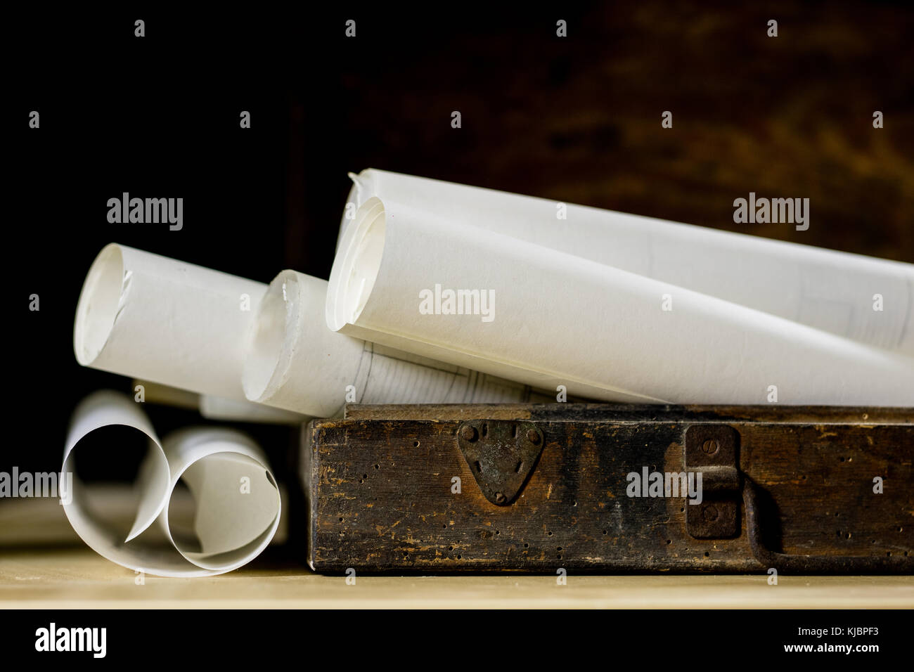 Old rolls and plans in folded paper rolls. Old book and case. Documents ...