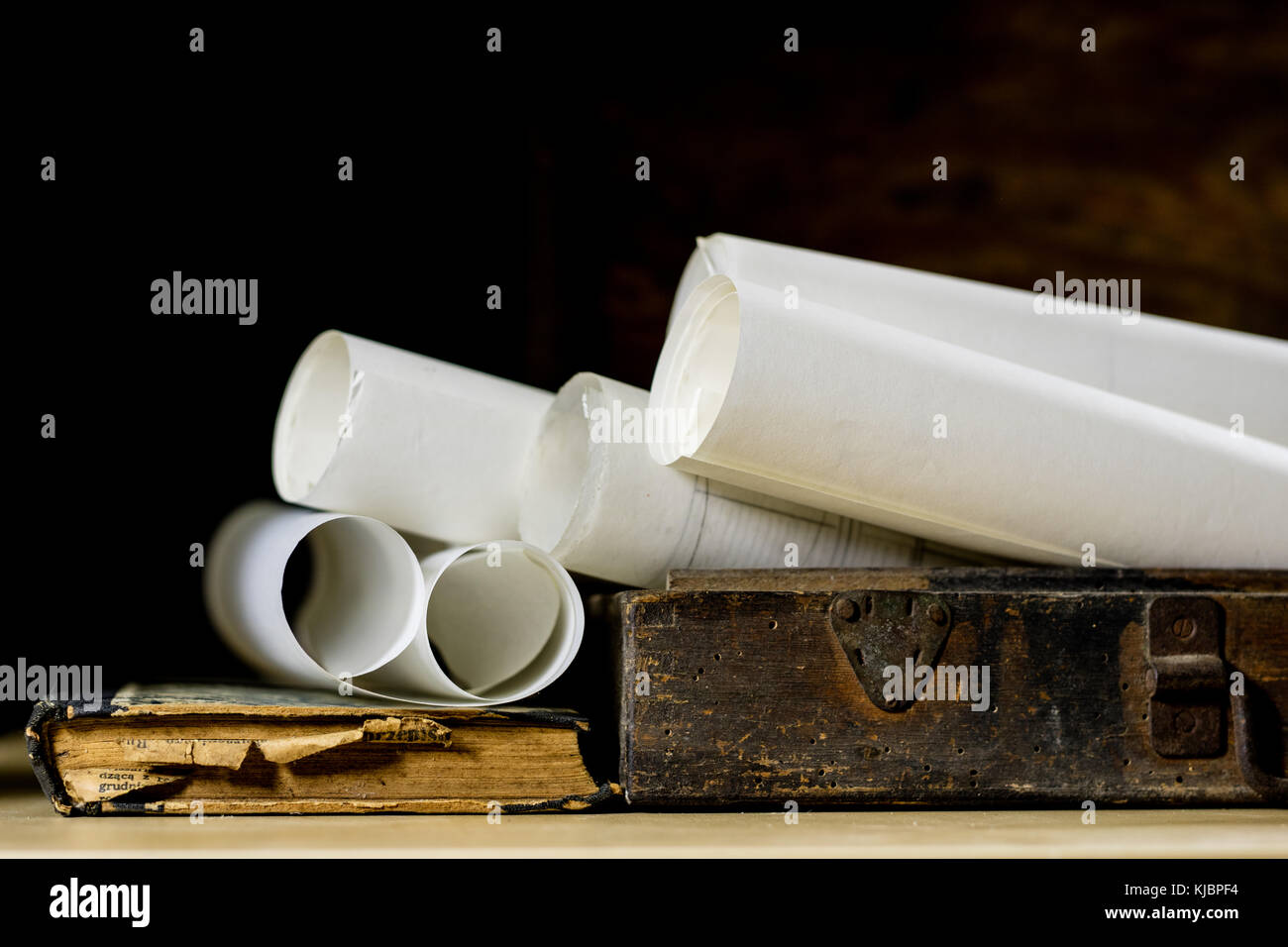 Old rolls and plans in folded paper rolls. Old book and case. Documents ...