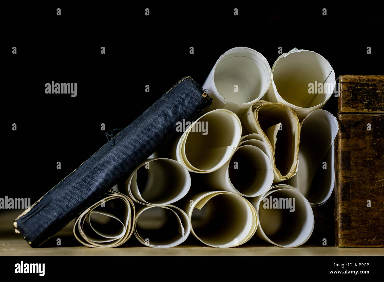 Old rolls and plans in folded paper rolls. Old book and case. Documents ...