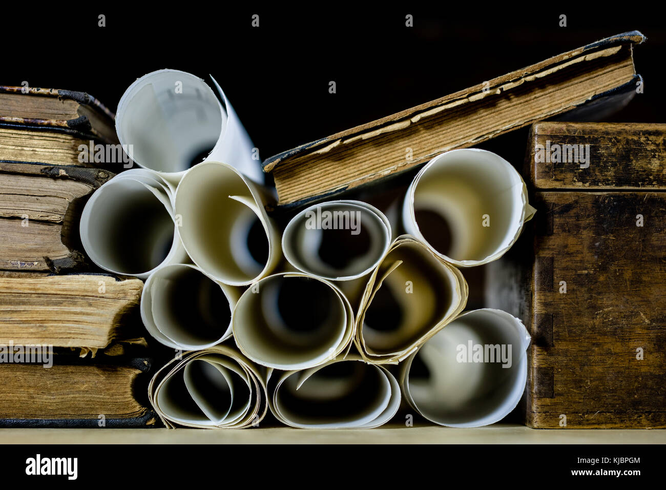 Old rolls and plans in folded paper rolls. Old book and case. Documents ...