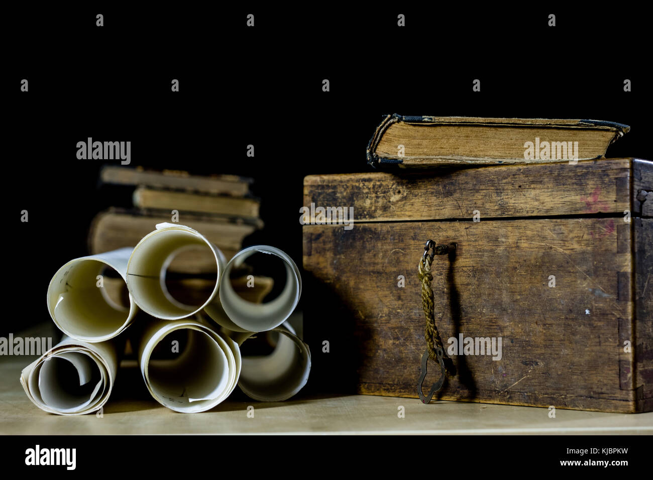 Old rolls and plans in folded paper rolls. Old book and case. Documents ...